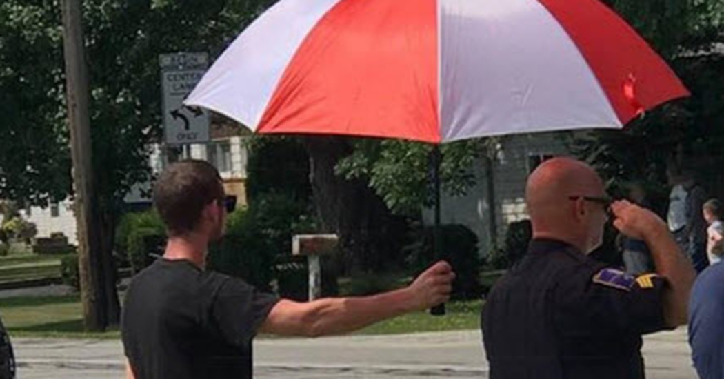 Man Holds Umbrella Over Police Officer While He Salutes Funeral ...